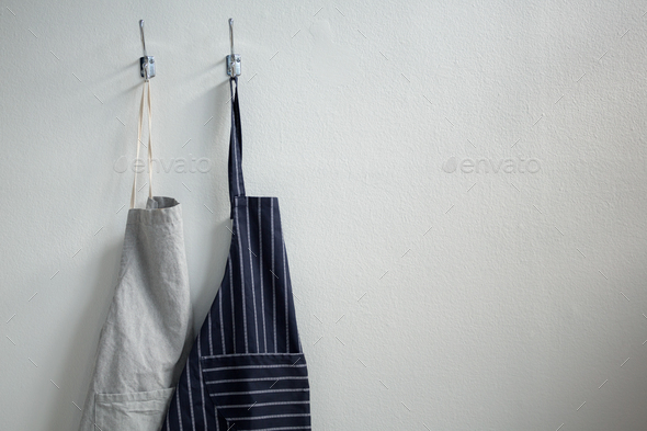 Aprons hanging on hook Stock Photo by Wavebreakmedia | PhotoDune