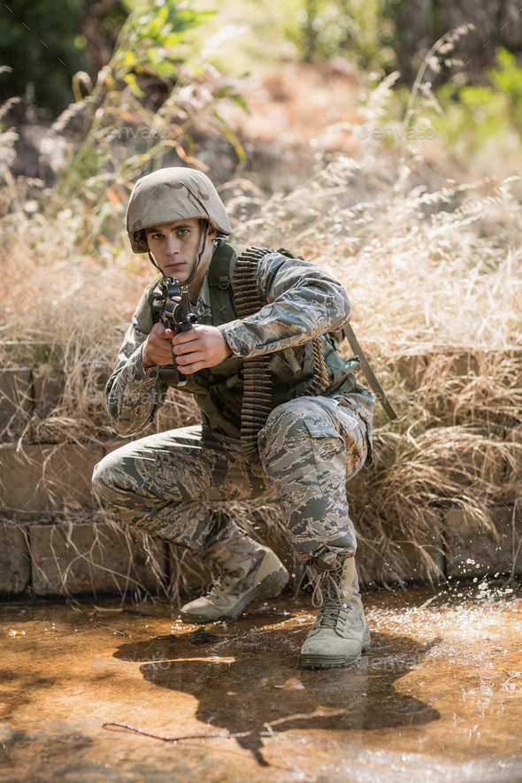 Military soldier aiming with a rifle Stock Photo by Wavebreakmedia