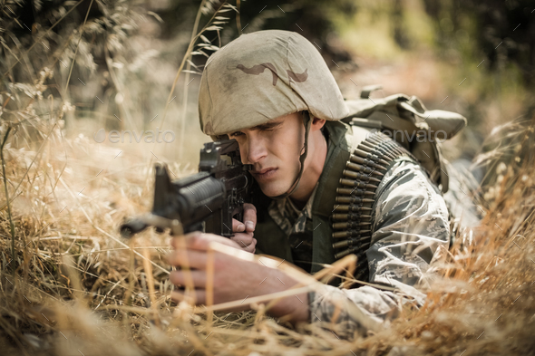 Military soldier aiming with a rifle Stock Photo by Wavebreakmedia