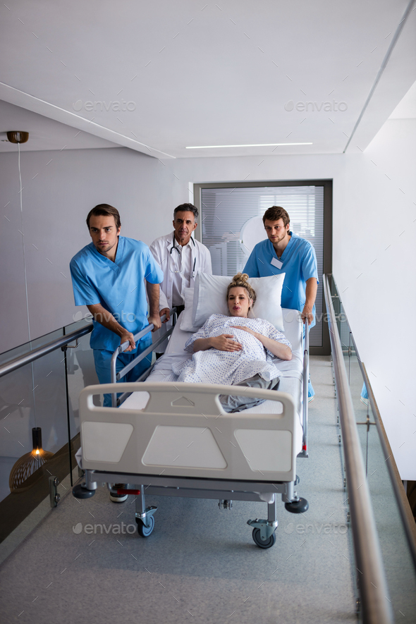 Team of doctors taking a pregnant woman to operation theatre Stock ...