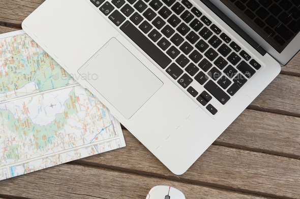 Laptop and world map on wooden plank Stock Photo by Wavebreakmedia
