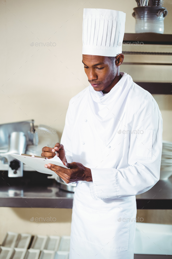 Chef writing notes on a clipboard Stock Photo by Wavebreakmedia | PhotoDune