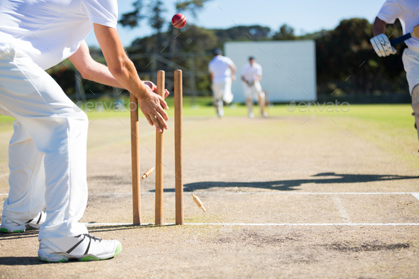 Wicket keeper hitting stumps during match Stock Photo by Wavebreakmedia