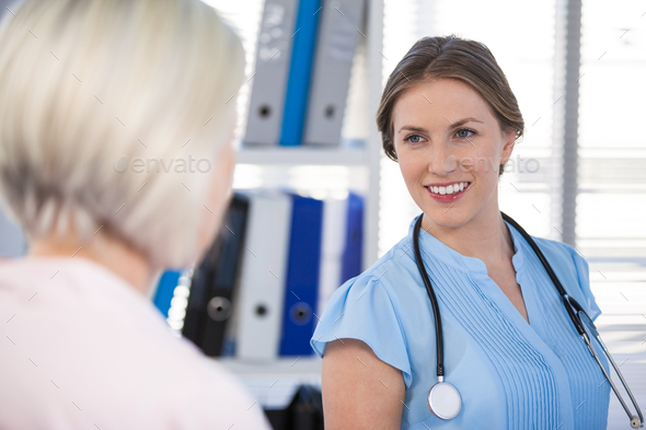 Doctor interacting with patient Stock Photo by Wavebreakmedia | PhotoDune