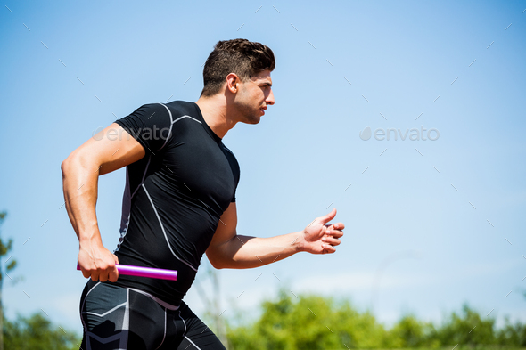 Relay athlete running with baton Stock Photo by Wavebreakmedia | PhotoDune