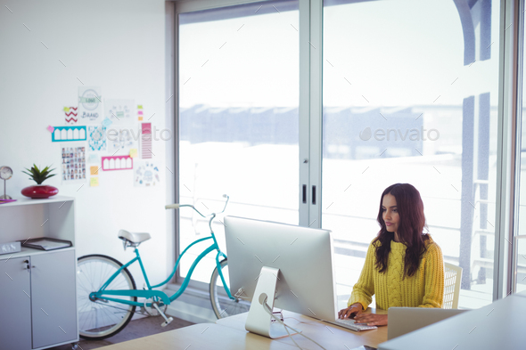 Female graphic designer using computer in office Stock Photo by ...