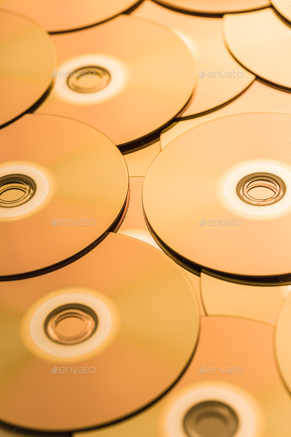 CDs and DVDs in golden tone as background Stock Photo by Brebca | PhotoDune