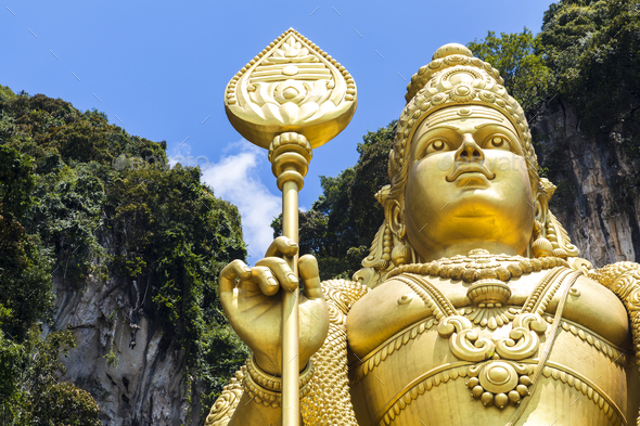 Low angle close up of colossal golden statue of Hindu deity. Stock ...