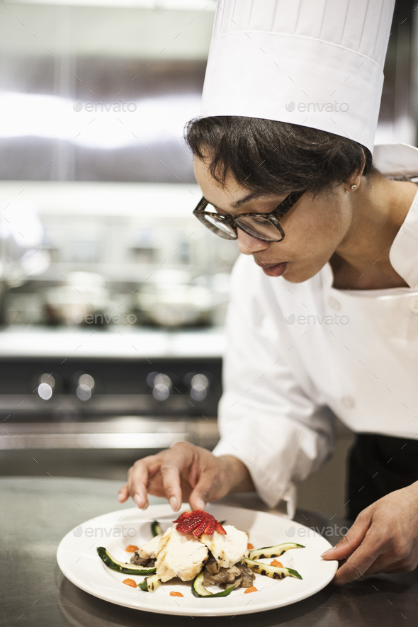 A black female chef working in a commercial kitchen, Stock Photo by ...