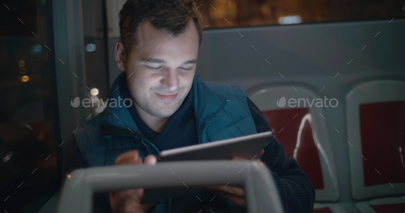 Passenger in the bus working with touch pad Stock Photo by Grey_Coast_Media