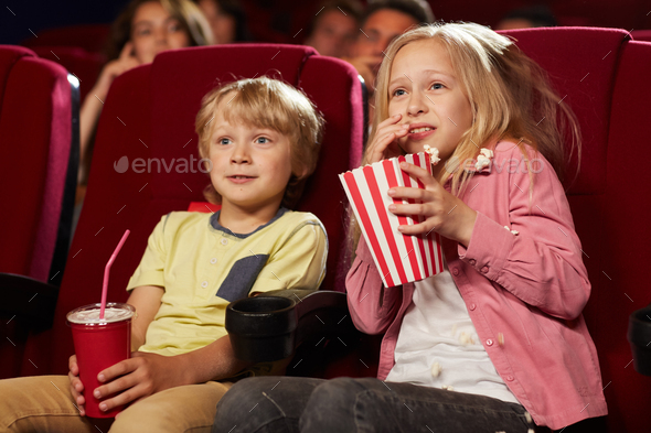 Children Watching Movie in Cinema Stock Photo by seventyfourimages