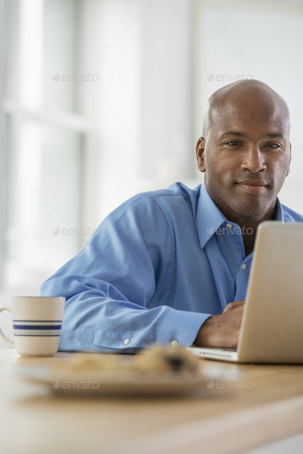 A business environment, an office workplace. A man sitting using a ...