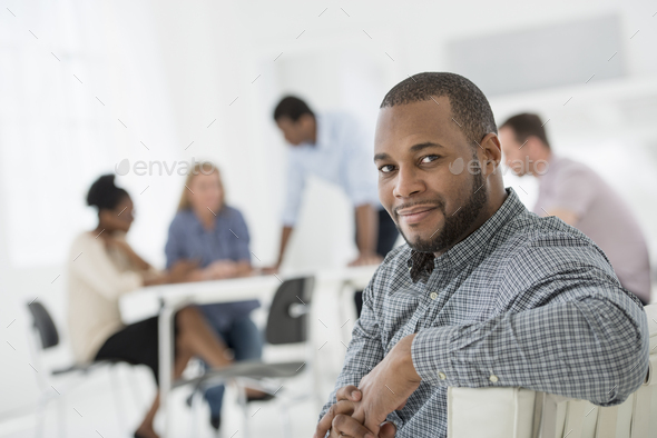 A group of people meeting. One person looking over her shoulder and ...