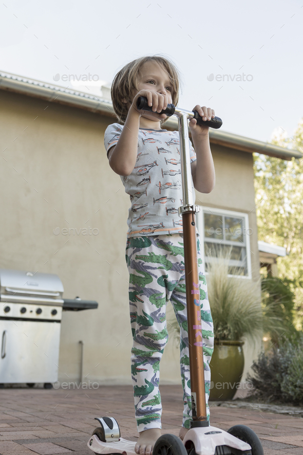 portrait of 4 yar old boy on his front porch Stock Photo by Mint_Images