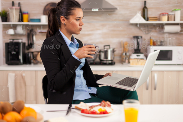 Using laptop in a modern kitchen Stock Photo by DC_Studio | PhotoDune