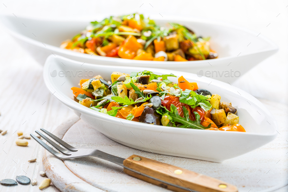 Mixed salad of roasted vegetables with rocket and seeds Stock Photo by ...