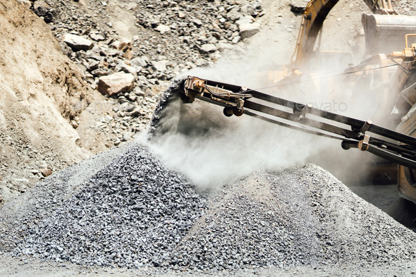 Stone breaker at industrial rock and marble quarry. Granite rocks ...