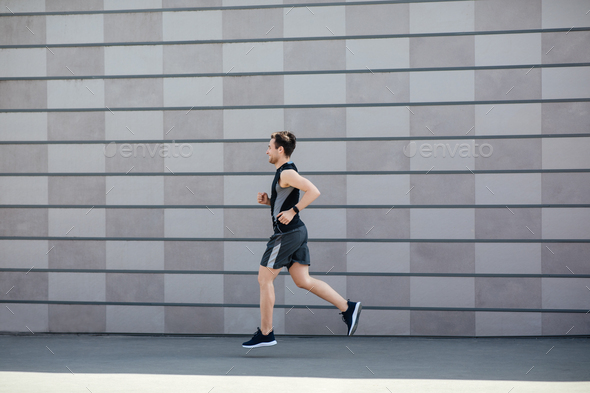 Athlete and jogging in morning. Muscular guy in sportswear and fitness ...