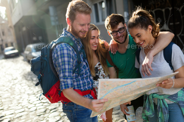 Happy group of tourists traveling and sightseeing Stock Photo by nd3000