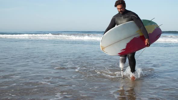 Front View of Man with Disability Going to Shore After Surfing, Stock ...