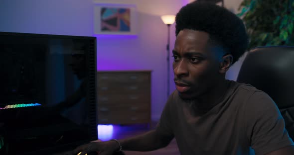 Professional Male Pro Gamer Sits Comfortably in Chair Leaning Over ...