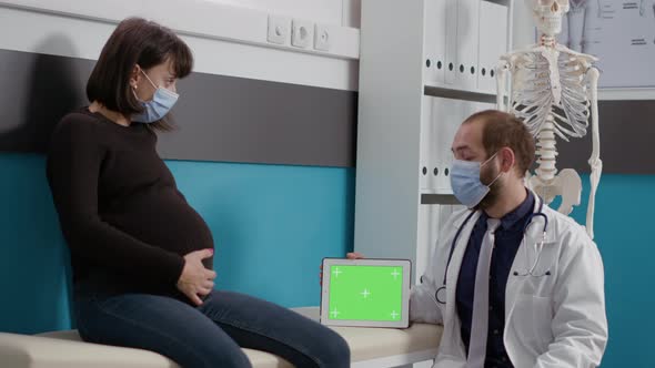 Woman with Pregnancy Belly Looking at Greenscreen Template, Stock Footage