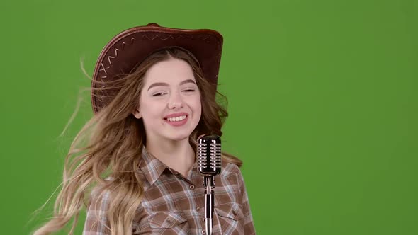 Singer in the Image of a Cowboy Sings in a Retro Microphone. Green ...