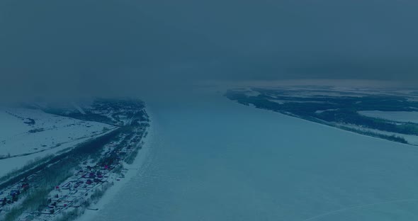 Quadcopter Flies Over a Wide Frozen River Ice Covers the River, Stock ...