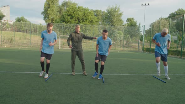 Soccer Players Performing Jog on the Spot Exercise Outdoors at Sunrise ...
