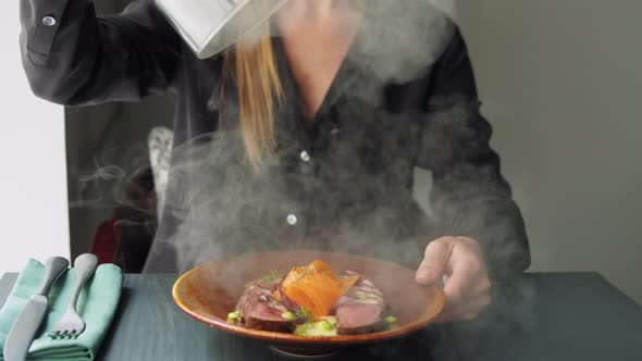 Waiter Serving Meat Dishes with Smoke To a Client in a Restaurant ...