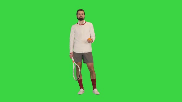 Tennis Player Holding a Racket and Tossing a Ball on a Green Screen ...