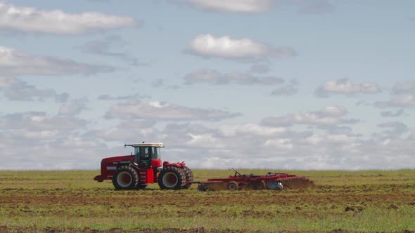 Red Tractor with a Reverse Plow Plows a Field, Stock Footage | VideoHive