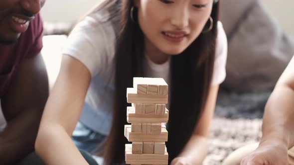Young Multi Ethnic People Playing Jenga Game Indoors, Stock Footage