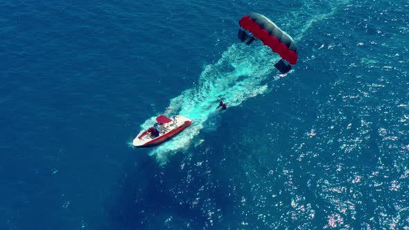 Aerial View. Flying with Parachute Behind a Boat. Extreme Water Sport ...
