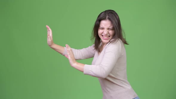 Young Beautiful Woman Resisting Something, Stock Footage | VideoHive