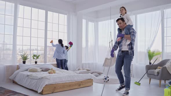 Dad Mopping Floor with Daughter on His Shoulders, Stock Footage | VideoHive