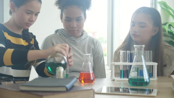 Young teacher teaching group student about science and explaining ...