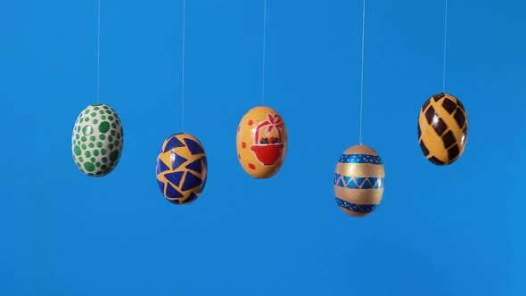 Colorful Easter Eggs Revolve Around Its Axis on a Blue Background with ...