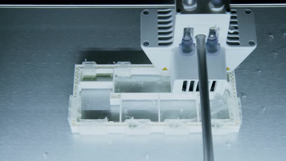 3D Printer module moving and working while printing a plastic Building ...