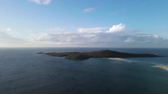 Unique view over water of a lush vegetated Island rising above the ...
