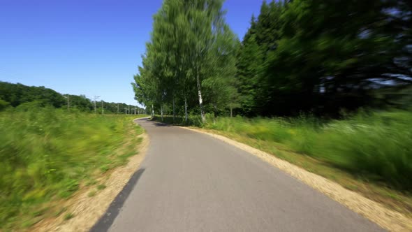 4K - Timelapse of a moving on a bike path through a field, Stock Footage