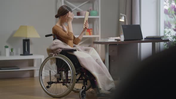 Charming Beautiful Caucasian Paraplegic Woman in Wheelchair Looking at ...
