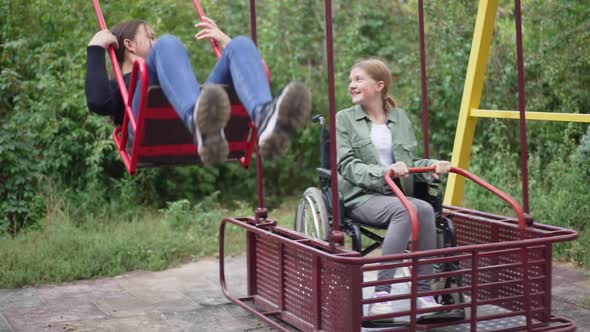 Excited Smiling Caucasian Disabled Girl in Wheelchair Swinging on ...