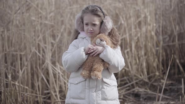 Portrait of Lost Caucasian Little Girl with Teddy Bear Crying Outdoors ...