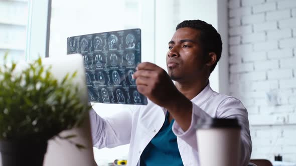 Close-up Face of African American Black Man Doctor Examining MRI Brain ...