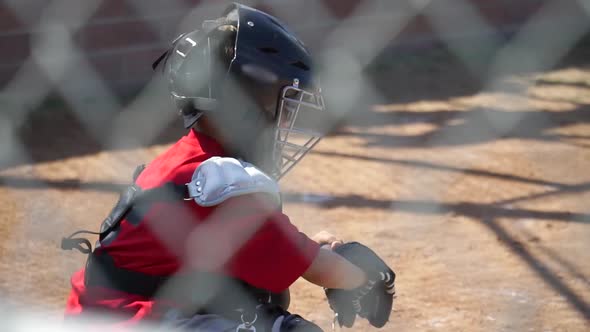 Close-up of a boy playing catcher for a little league baseball team ...