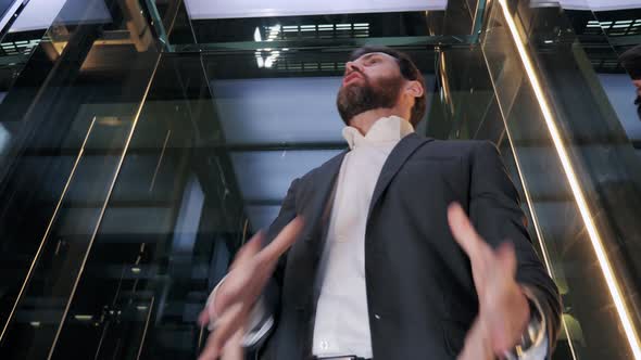 Stressed Angry Out Business Man Going Up From Office in a Glass ...