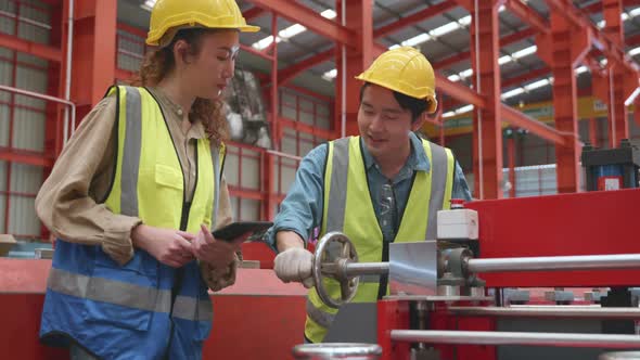 Industrial engineer man and worker operation woman training work on ...