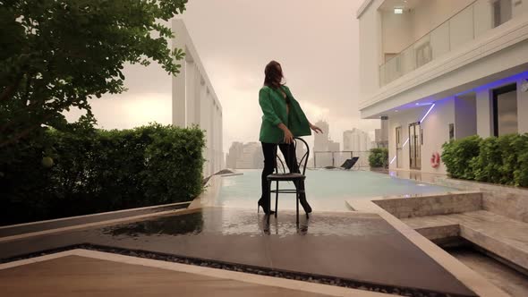 Dancer Posing By Chair And Crouching At Poolside, Stock Footage | VideoHive