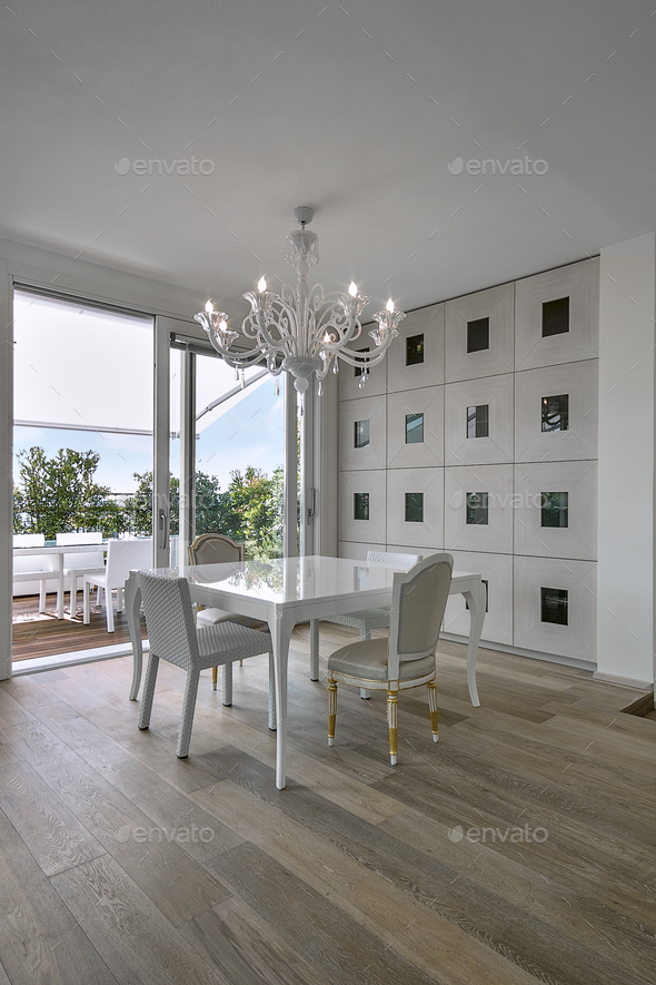 Modern Dining Table in a Living Room with Old Chandelier overlooking on ...